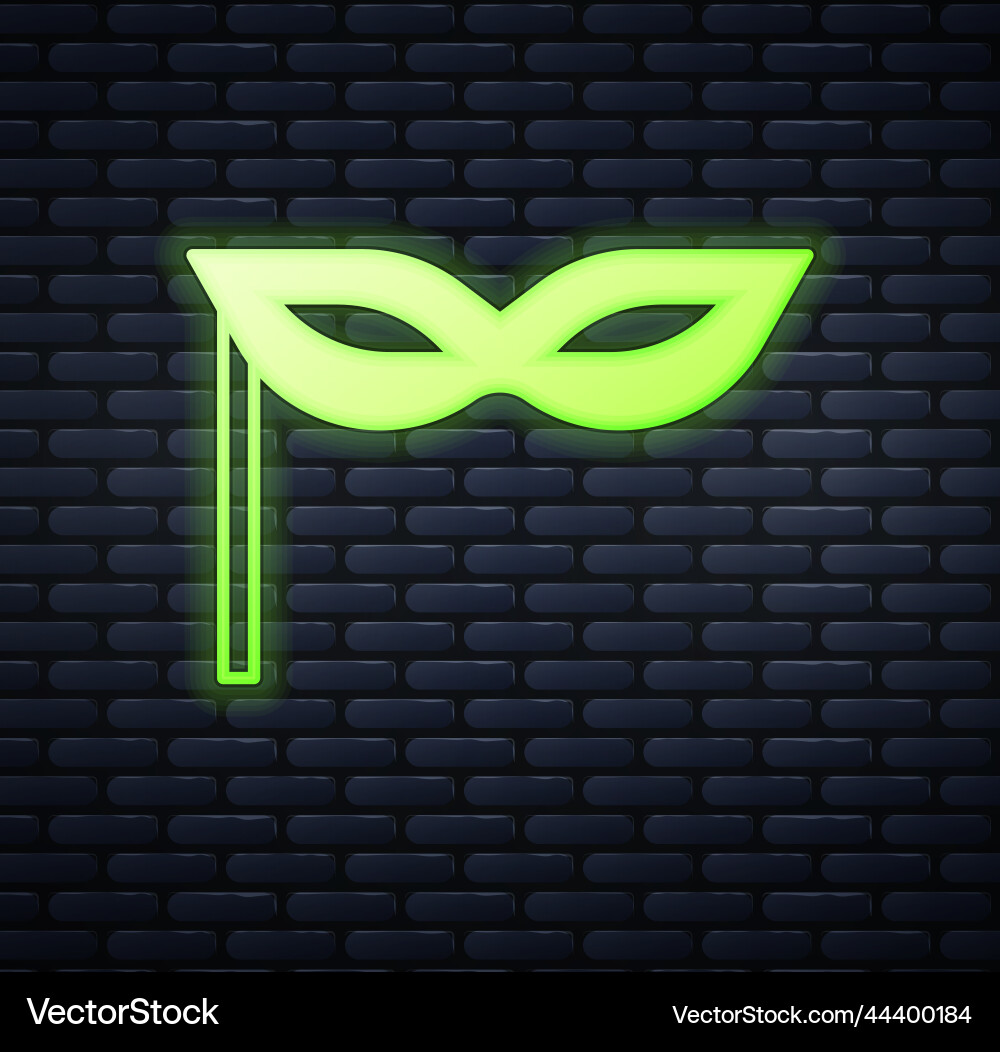 Glowing neon carnival mask icon isolated on brick Vector Image