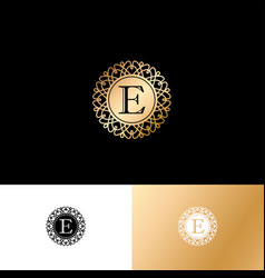 E gold letter with swirly ornaments Royalty Free Vector